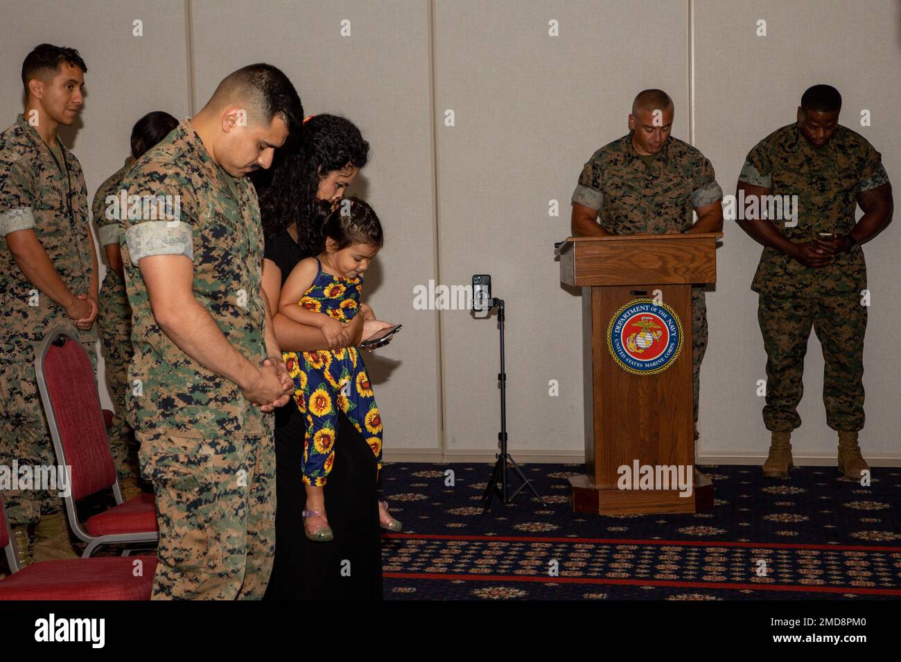 U.S. Marine Corps Capt. Moses R. Menchaca and his family bow their ...