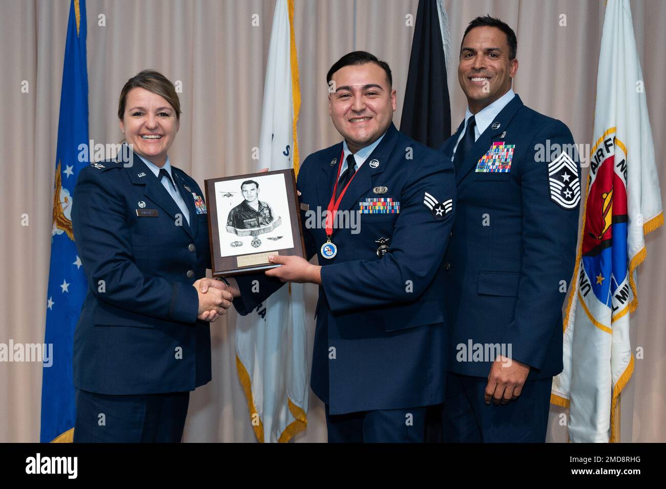 Col. Taona Enriquez, installation commander, left, and Chief Master Sgt ...