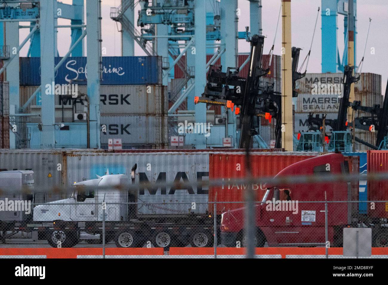 In this Monday, Oct. 18, 2021, file photo trucks line up to load ...