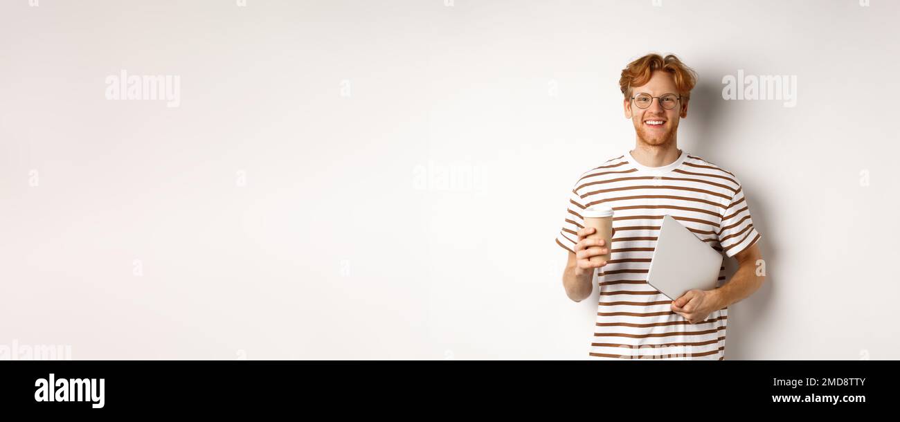 Handsome redhead male employee in glasses having break, drinking coffee ...
