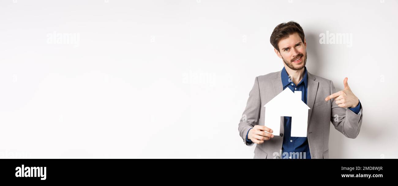 Real estate and insurance concept. Salesman in grey suit showing paper ...