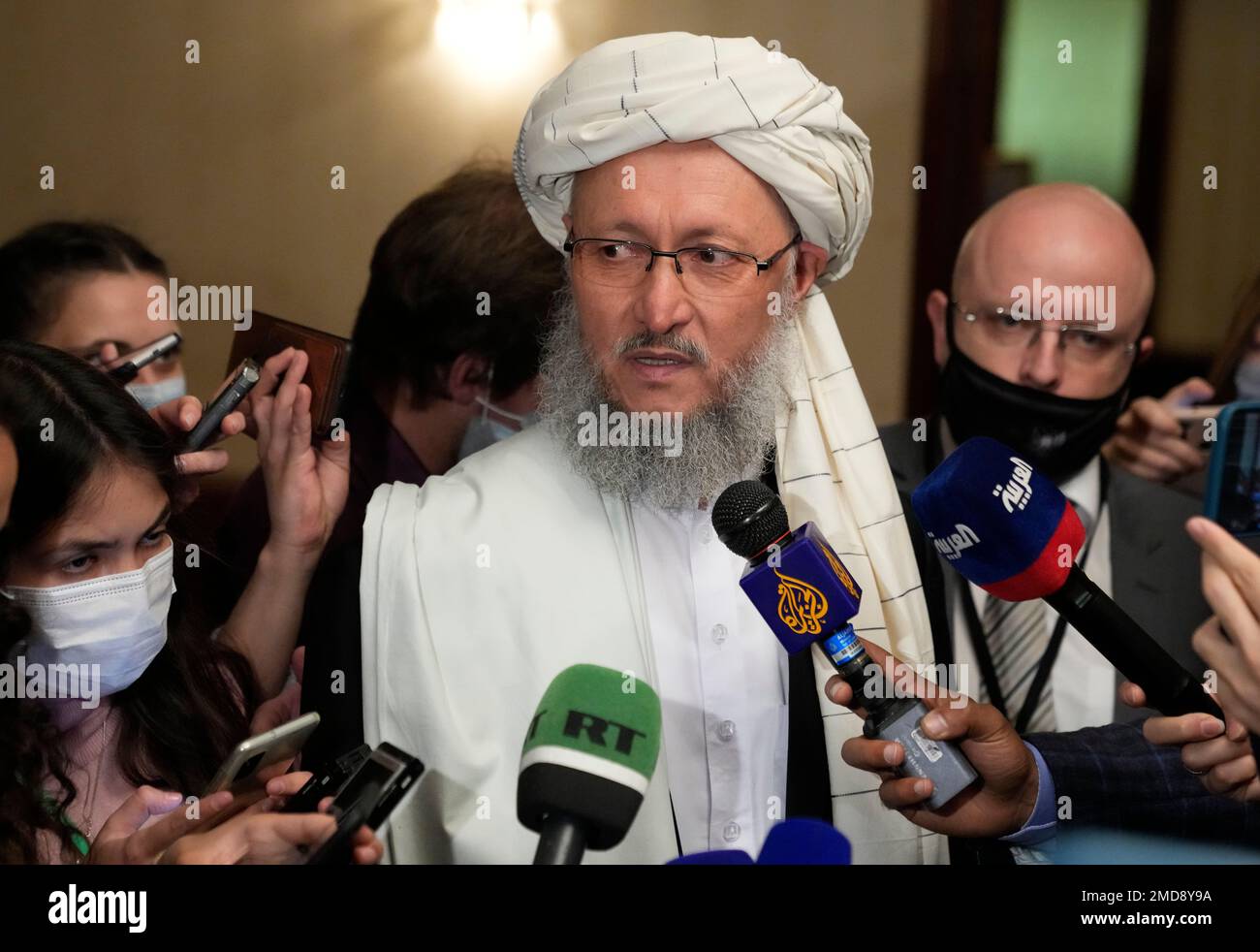 Taliban official Abdul Salam Hanafi, center, speaks to media during ...