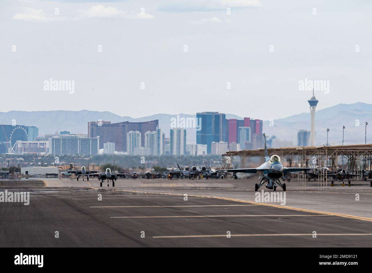 Various aircraft taxi down the flightline during Red Flag 22-3 ...
