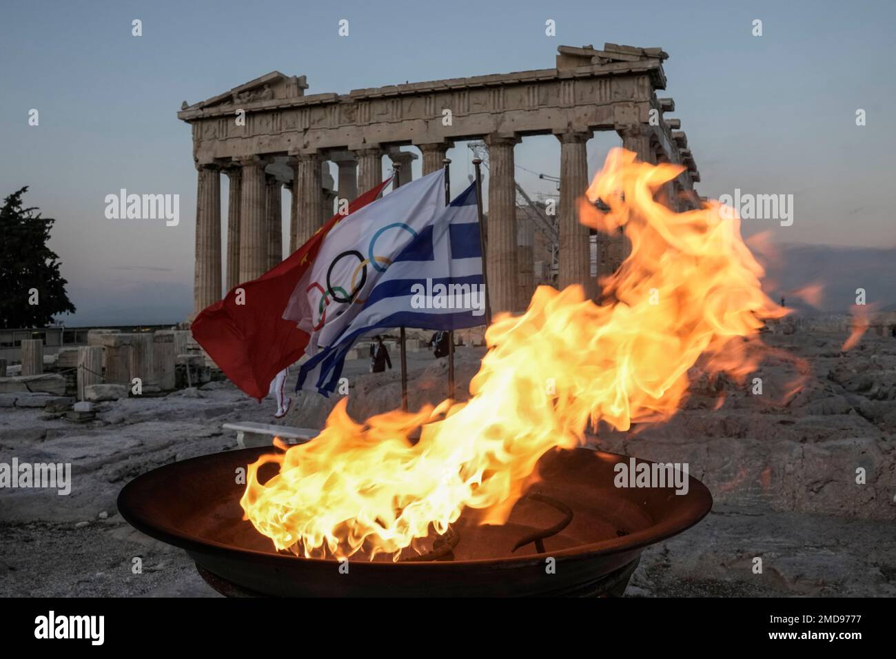 The Olympic Flame burns at the cauldron in front of ancient Parthenon ...