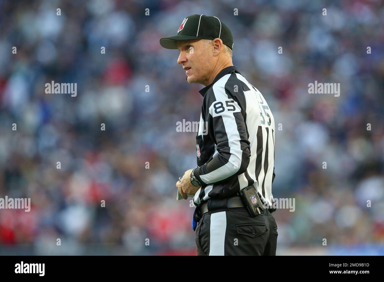 Line judge Daniel Gallagher (85) writes down notes during the first ...