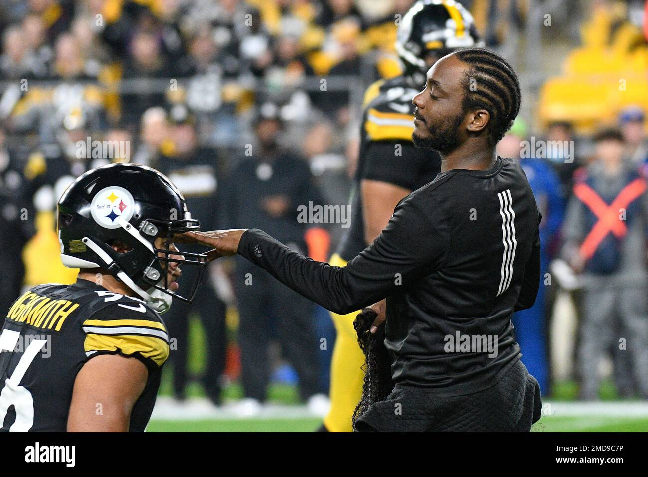 A fan walks on the field of play during an NFL football game between ...