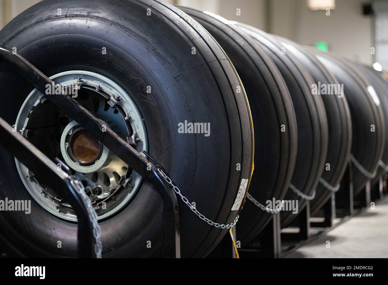 A row of C-17 Globemaster III tires are racked at the wheel and tire ...