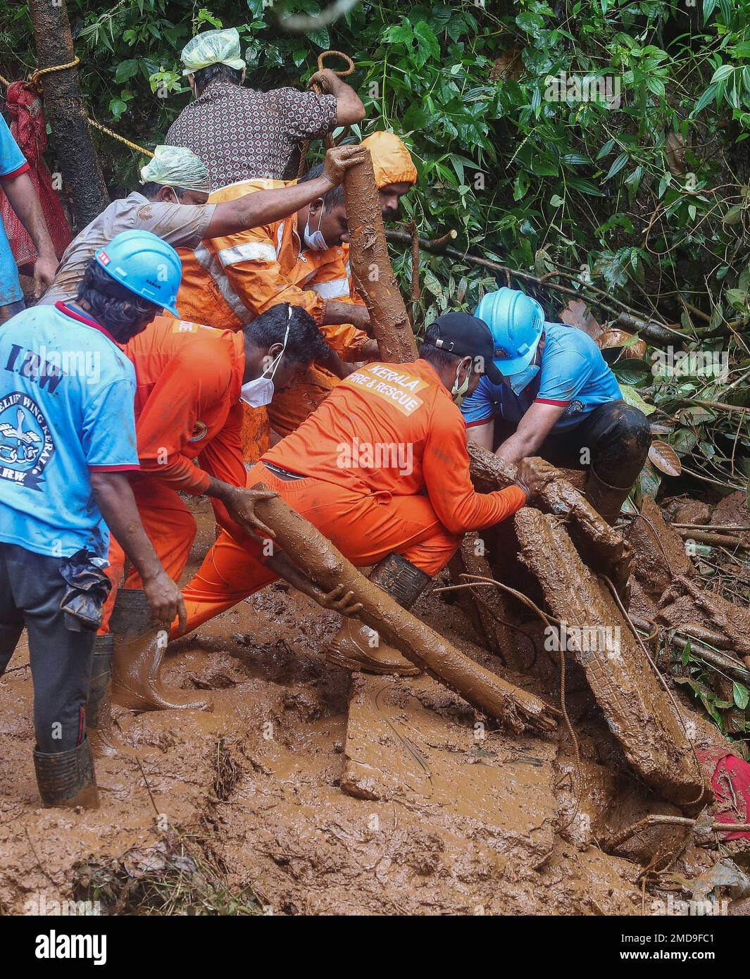 Rescuers try to pull out the body of a victim from beneath the debris ...