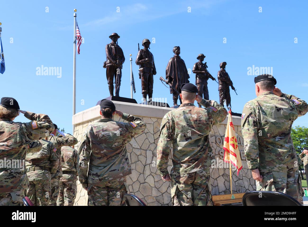 Members of the official party salute as the national anthem is played ...