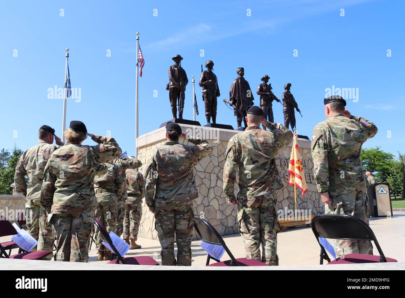 Members of the official party salute as the national anthem is played ...