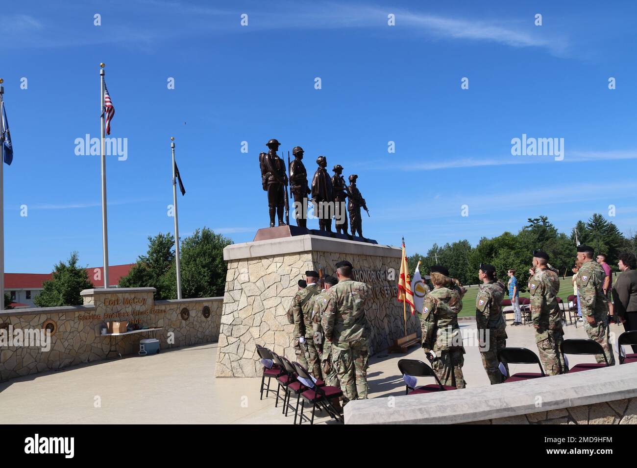 Members of the official party salute as the national anthem is played ...