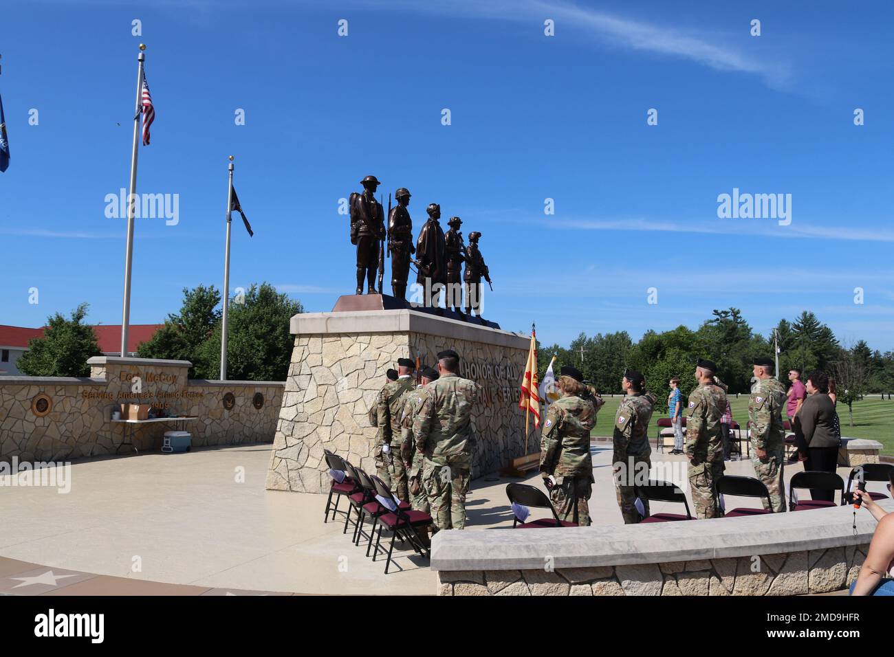 Members of the official party salute as the national anthem is played ...