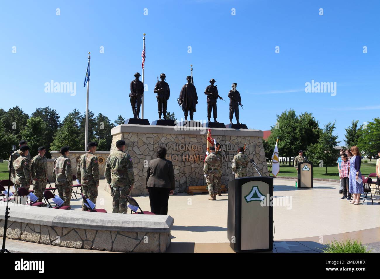 Members of the official party salute as the national anthem is played ...