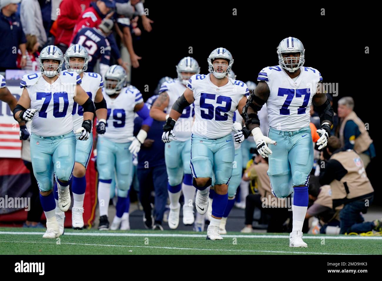 Dallas Cowboys run onto the field before the first half of an NFL ...