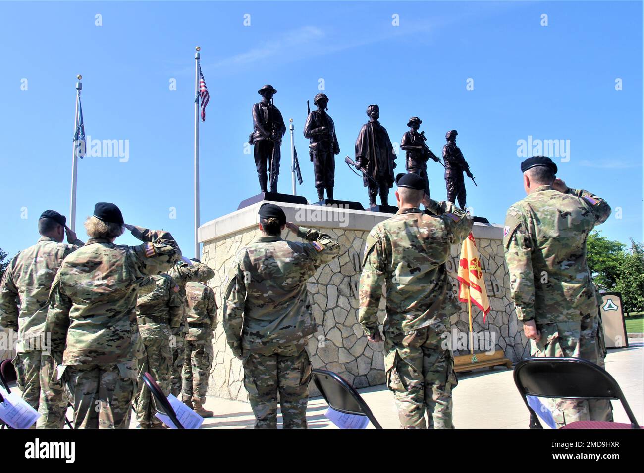 Members of the official party salute as the national anthem is played ...