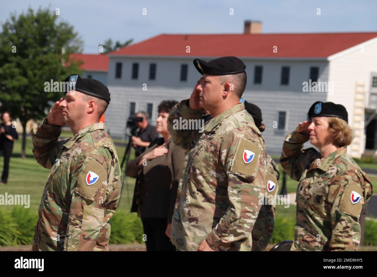 Members of the official party salute as the national anthem is played ...