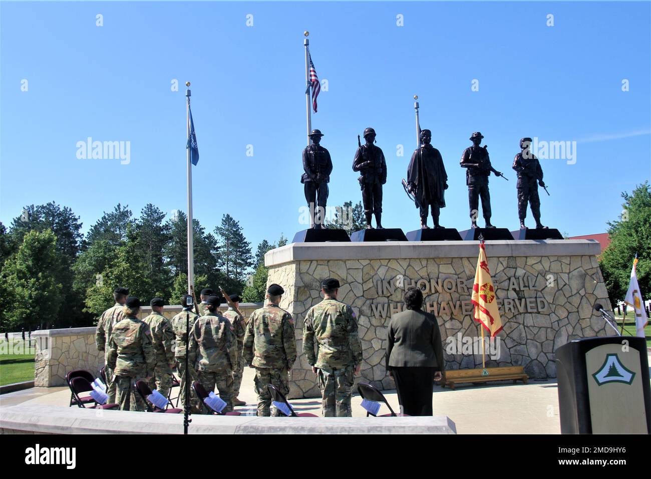 Members of the official party salute as the national anthem is played ...