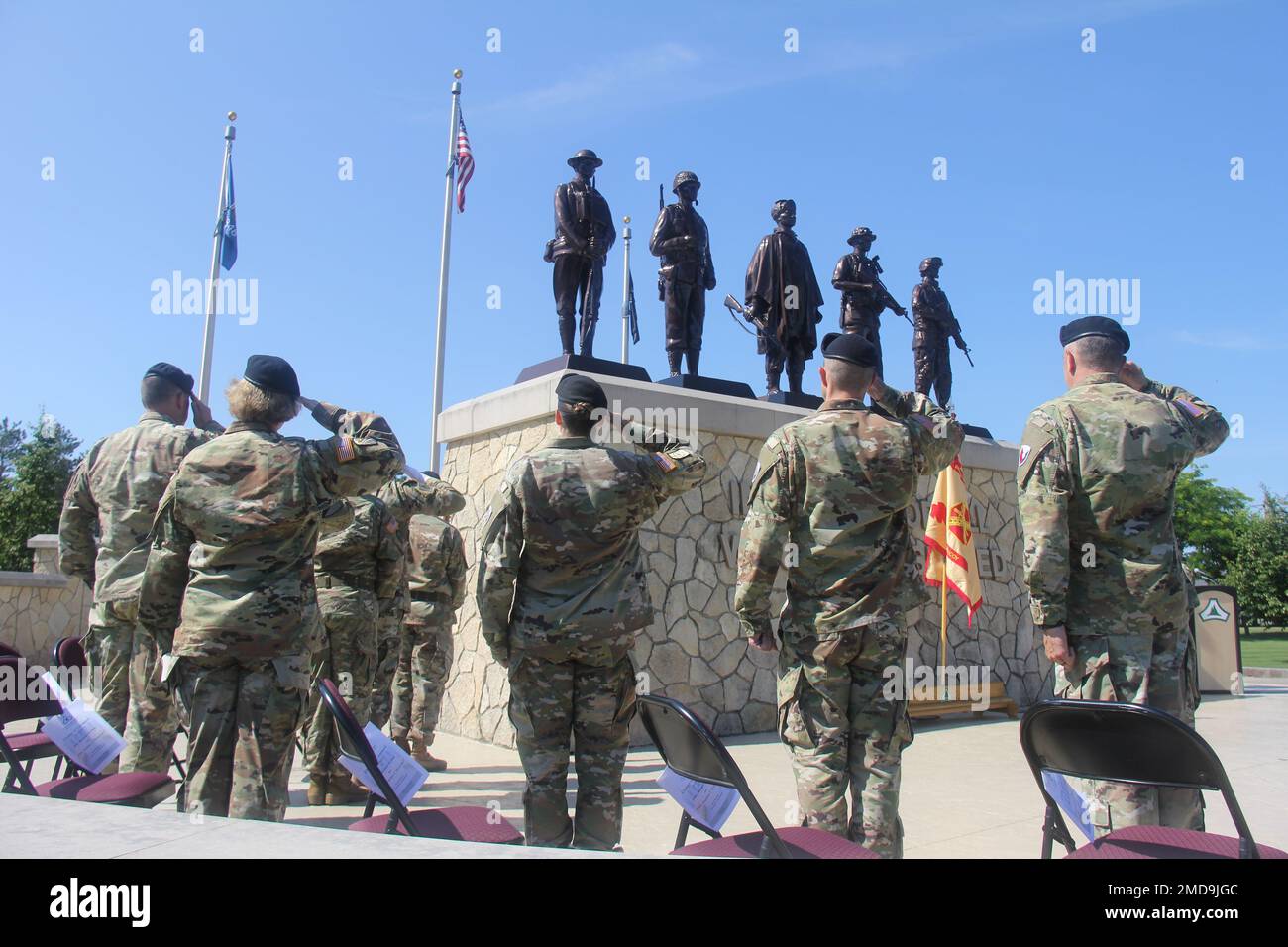 Members of the official party salute as the national anthem is played ...