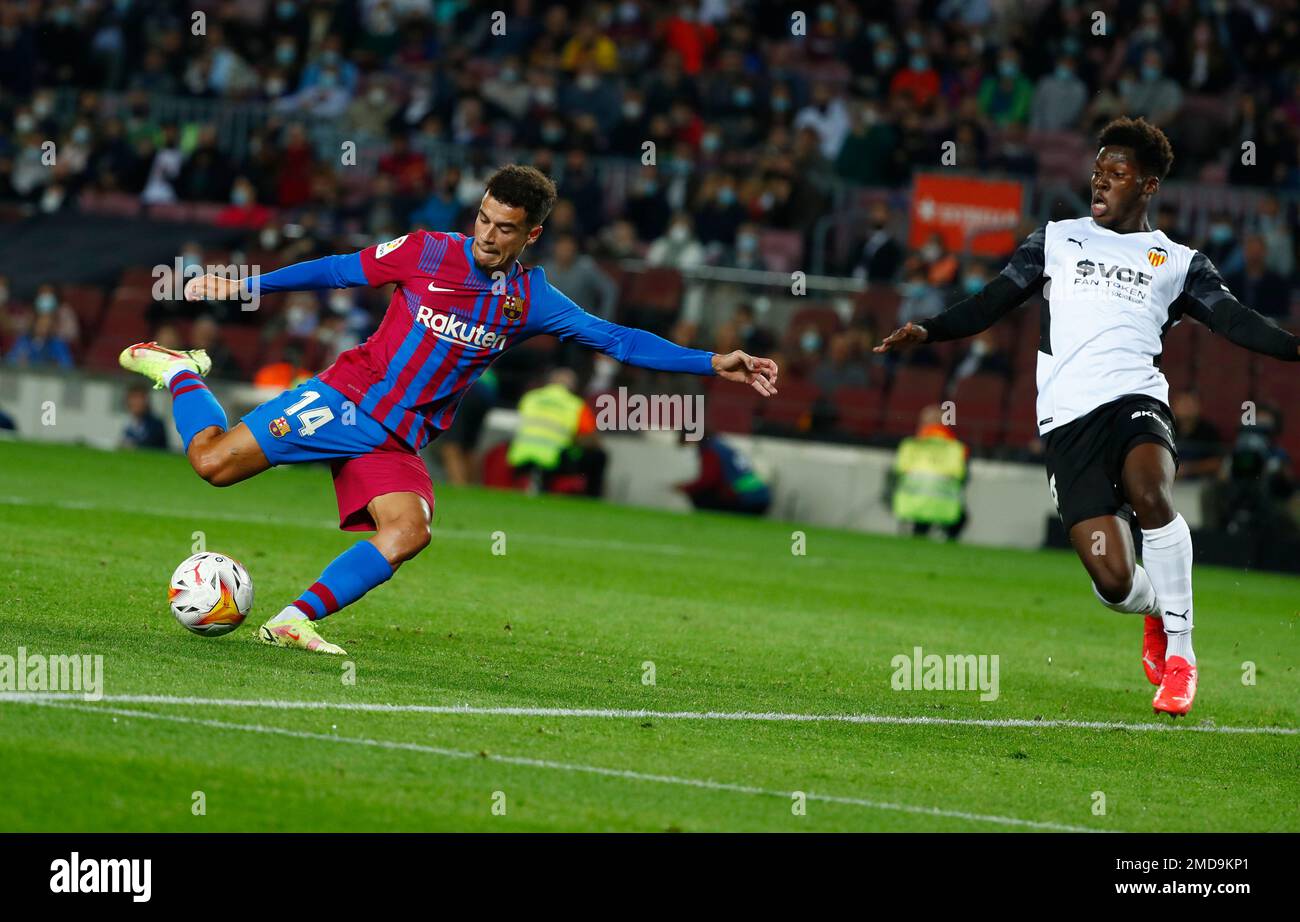Barcelona's Philippe Coutinho, left, scores his side's third goal ...