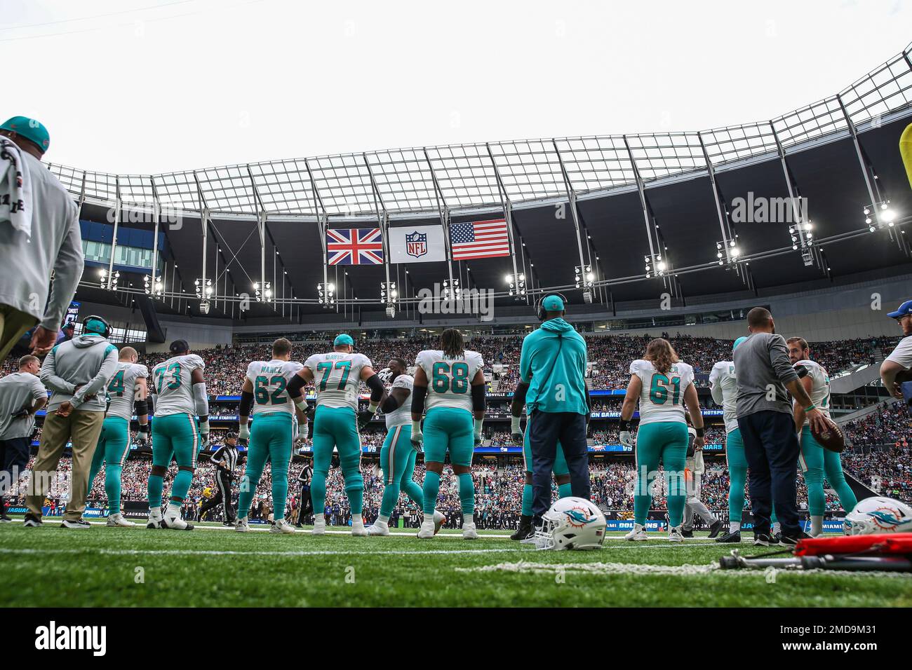 The Miami Dolphins line the field during a rendition of God Save the ...
