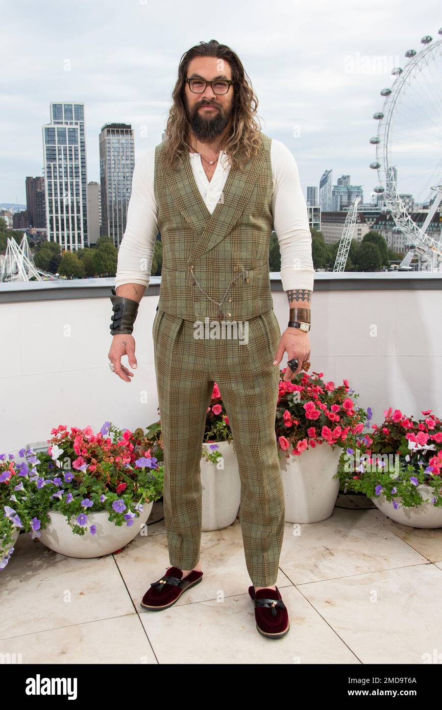 Jason Momoa poses for photographers at the photo call for the film ...