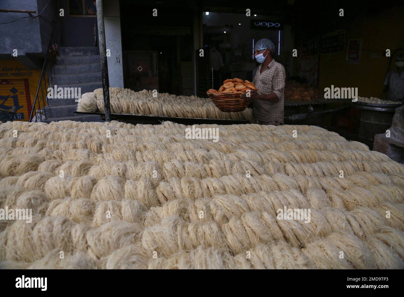 An Indian baker dries vermicelli to make a delicacy that is in demand ...