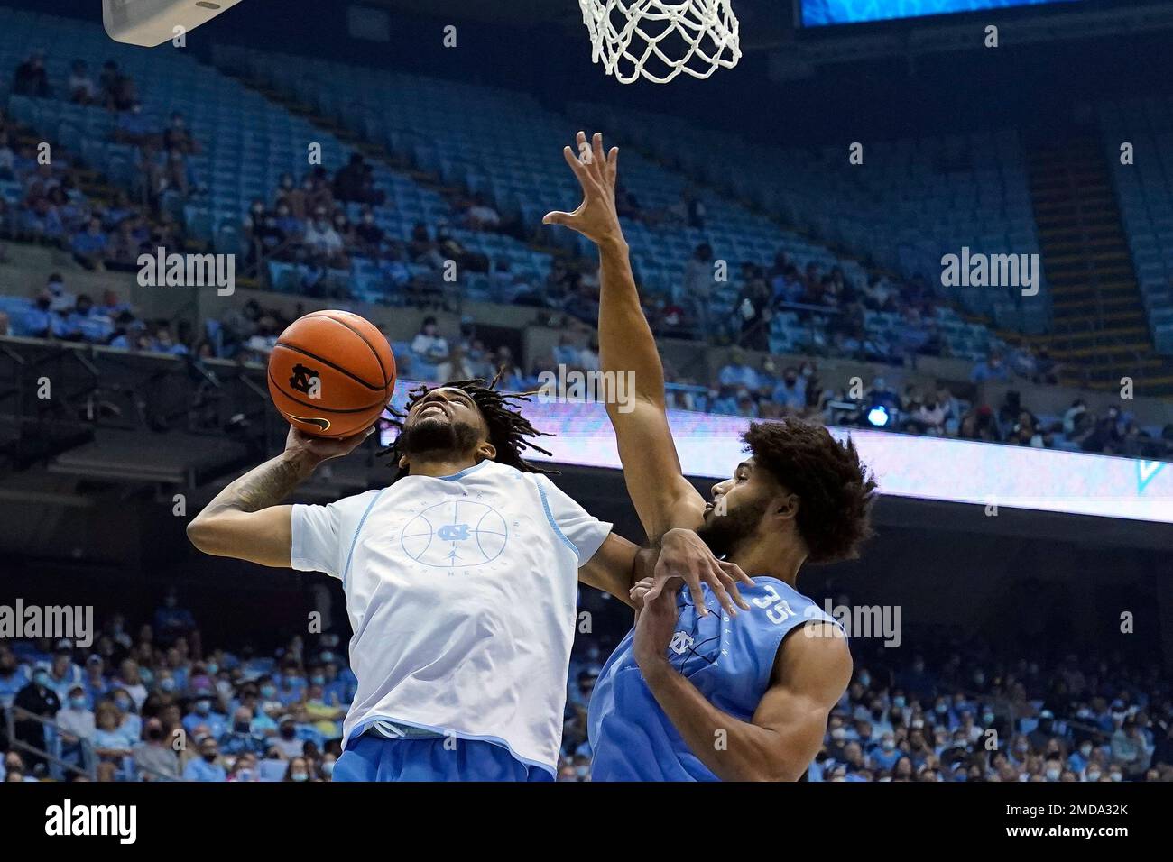 North Carolina's RJ Davis shoots while Ryan McAdoo (35) defends during ...