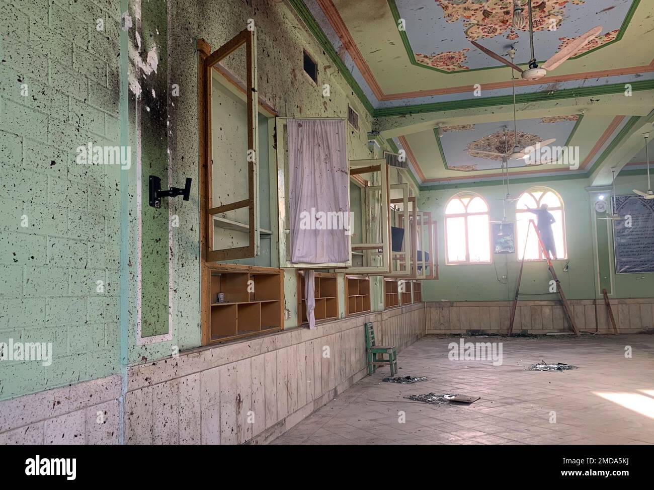 An Afghan man inspect the inside of a mosque following a suicide ...