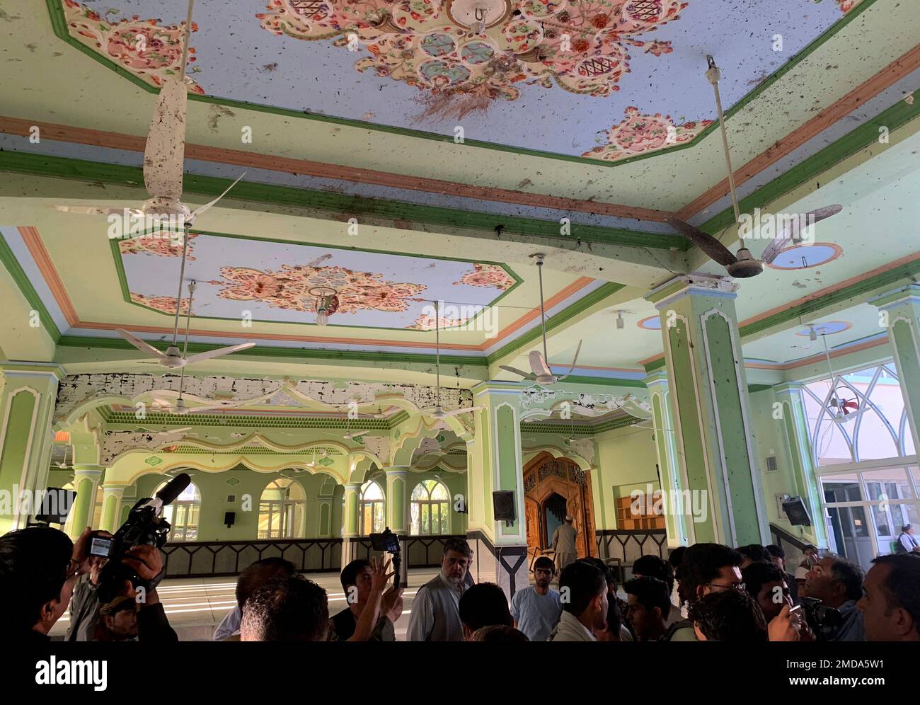 Journalists take photos of a blood stains from the top of a mosque ...