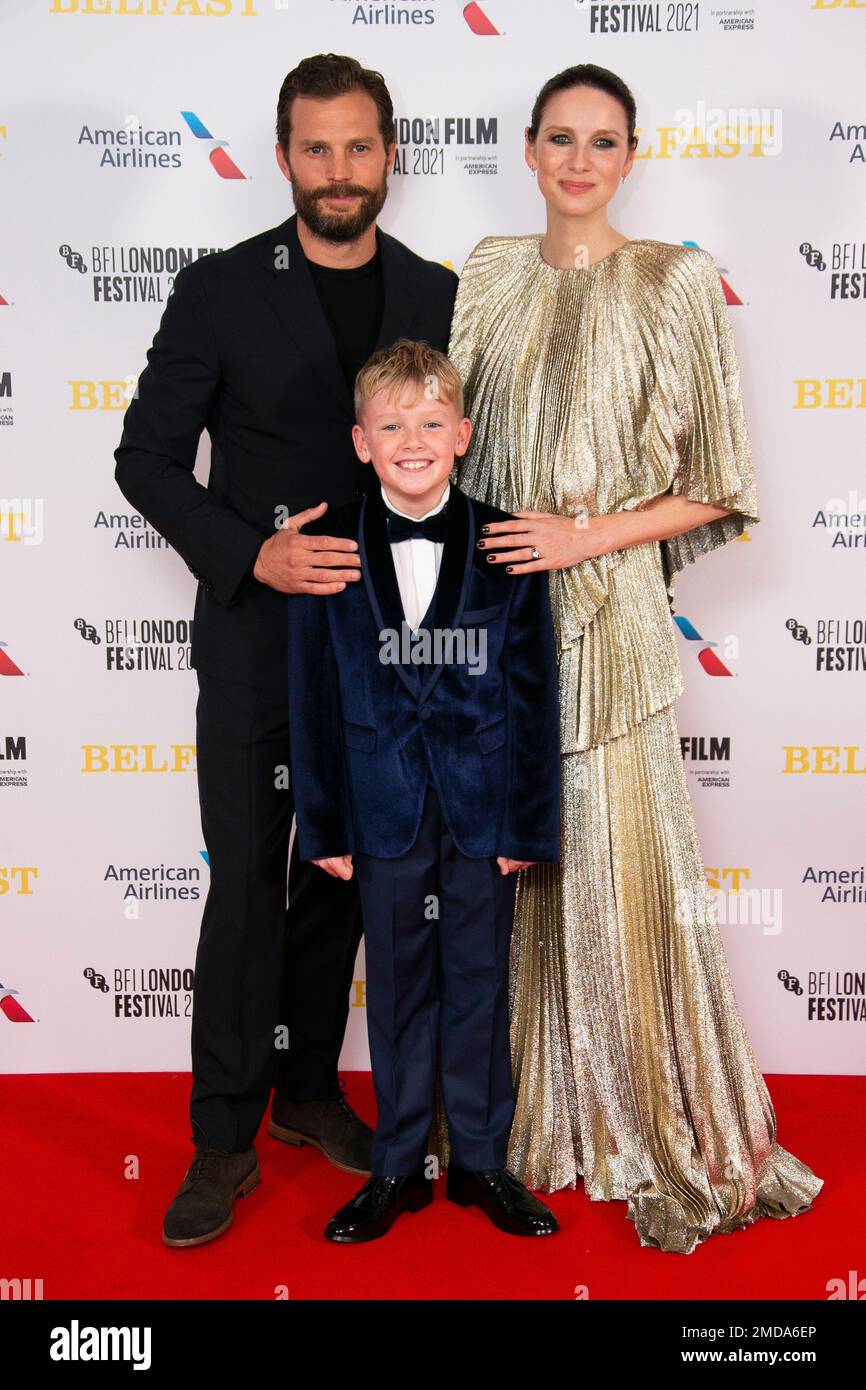 From left, Jamie Dornan, Jude Hill and Caitriona Balfe pose for ...