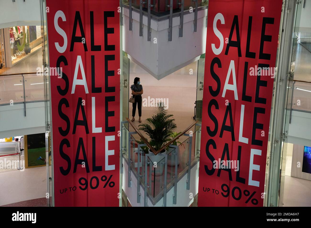 Customer wait an elevator beside sales advertisement at shopping mall ...