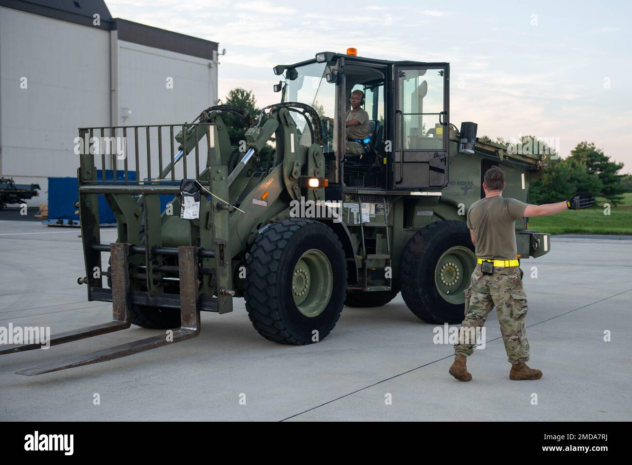 Members from the 46th Aerial Port Squadron operate a 10K forklift ...