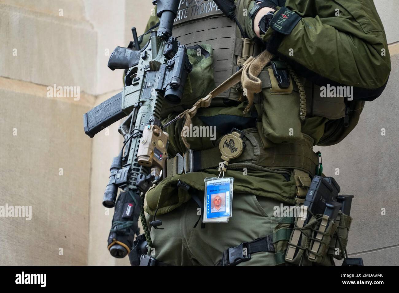 A member of the Georgia State Patrol SWAT team looks on as people walk ...