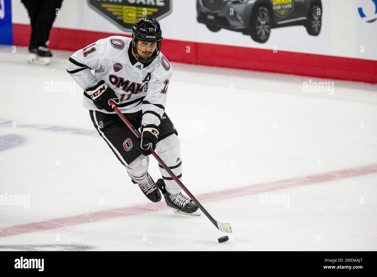 Omaha forward Nolan Sullivan (11) skates with the puck against Maine in ...