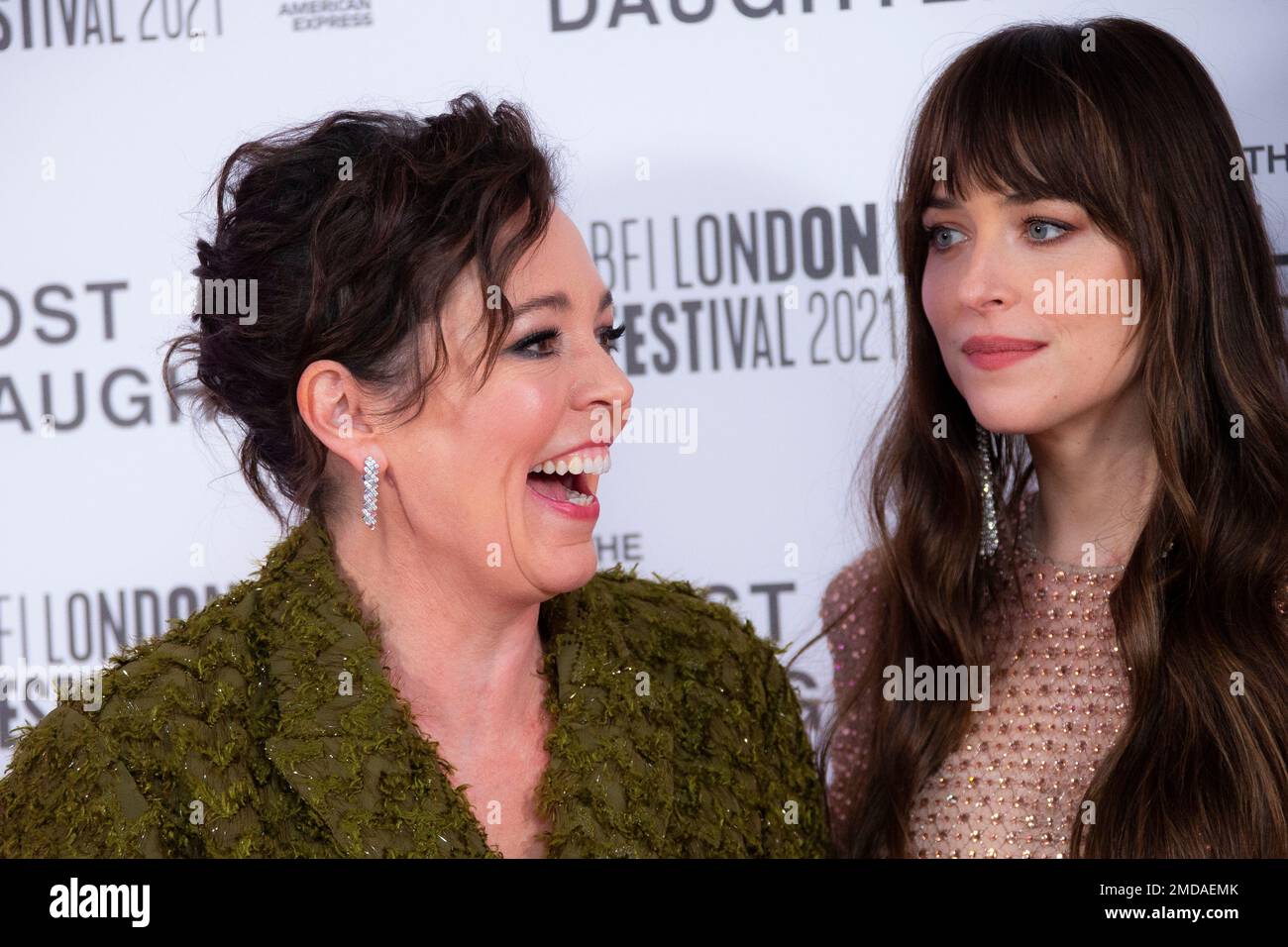 Olivia Colman laughs with Dakota Johnson upon arrival at the premiere ...