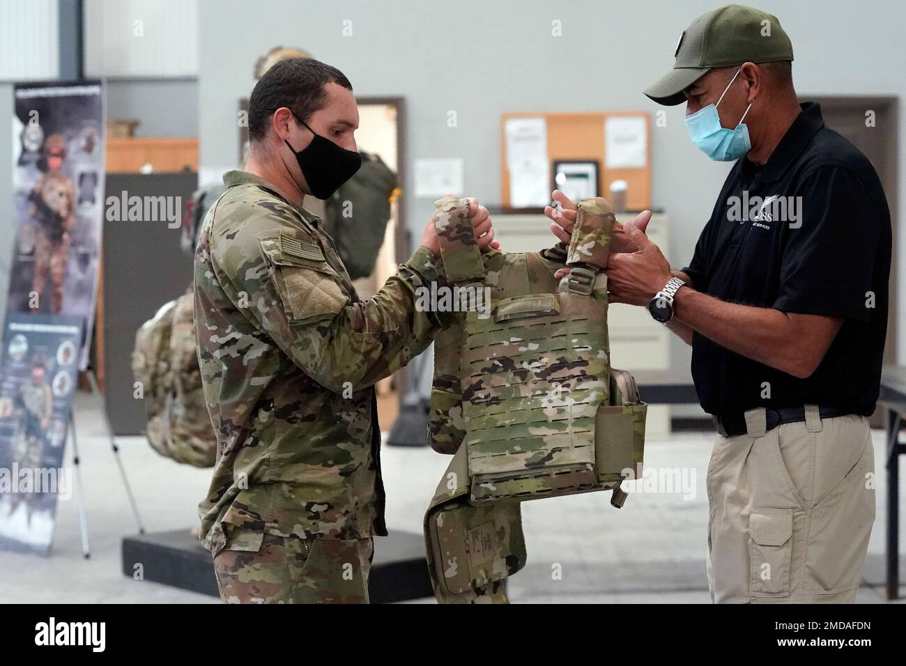 U.S. Army Spc. Khalil Abdel, left, is fitted with the new modular ...