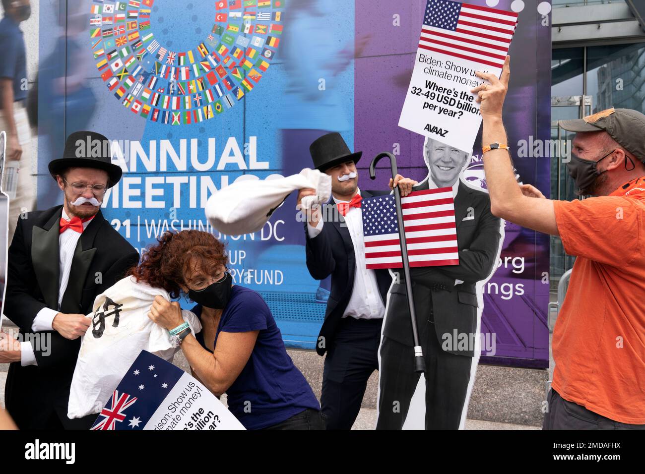 Activists holding a cardboard cutouts of President Joe Biden protest ...