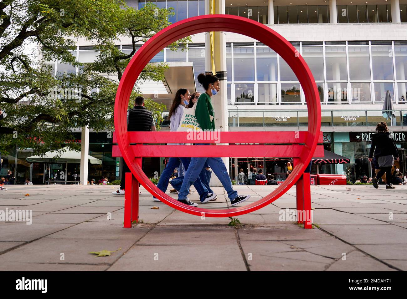 People walk along the south bank of the river Thames, in London, Wednesday, Oct. 13, 2021.(AP ...