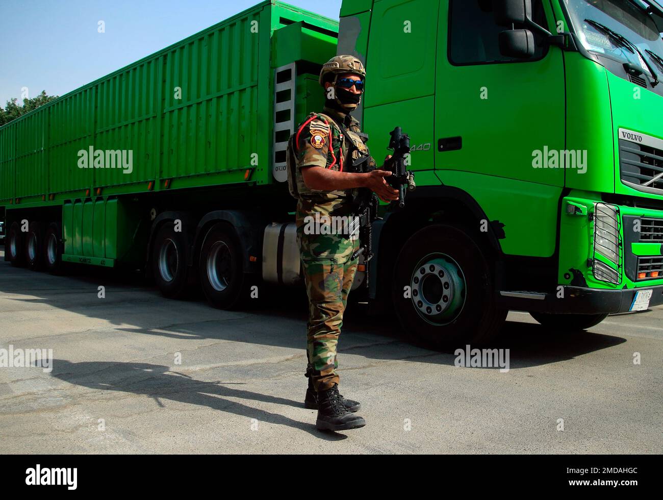 Iraqi security forces stand guard as ballot boxes arrive to a manual ...