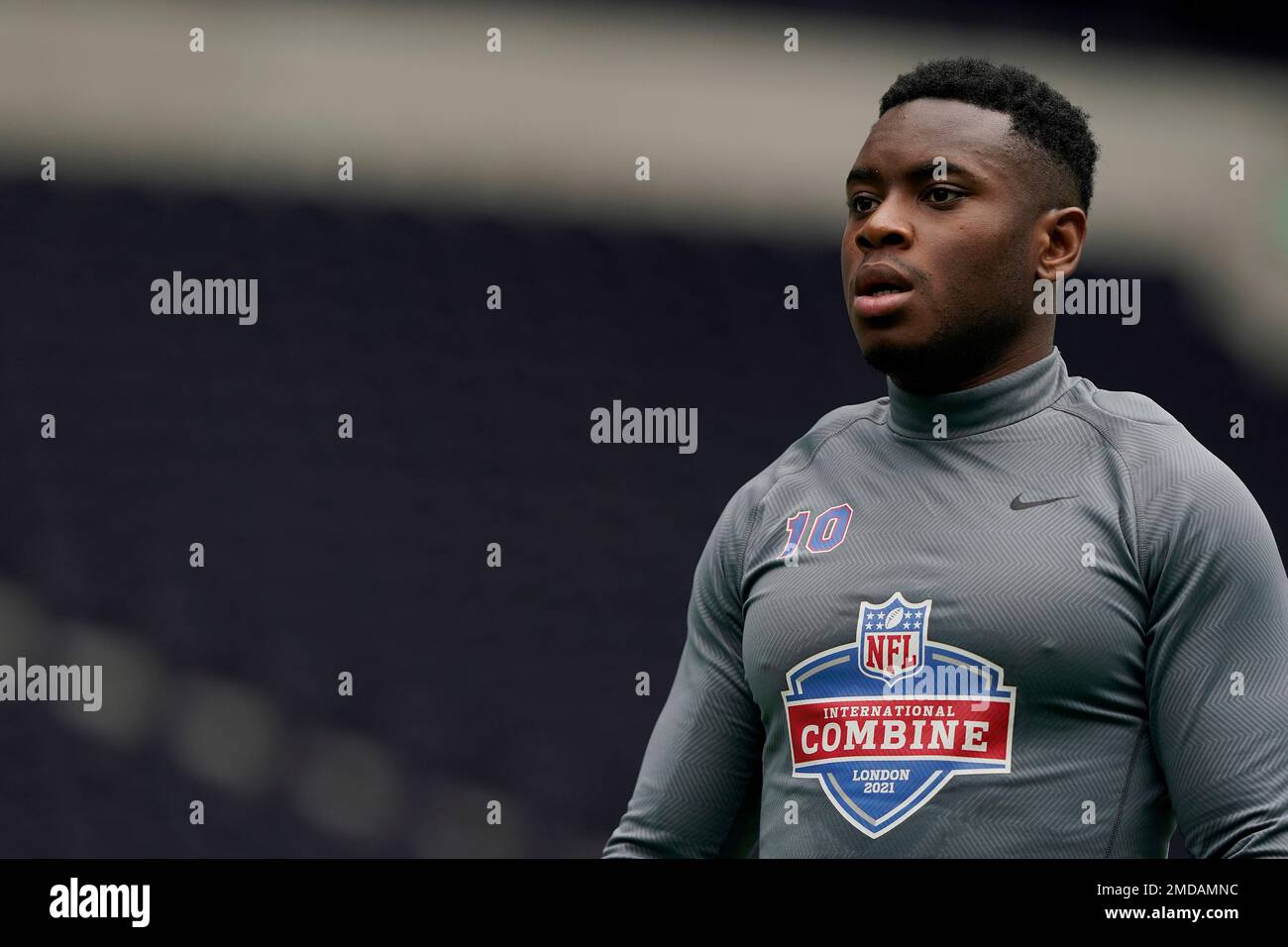 Running back Joshua Addams, of Britain, walks on the field participates ...