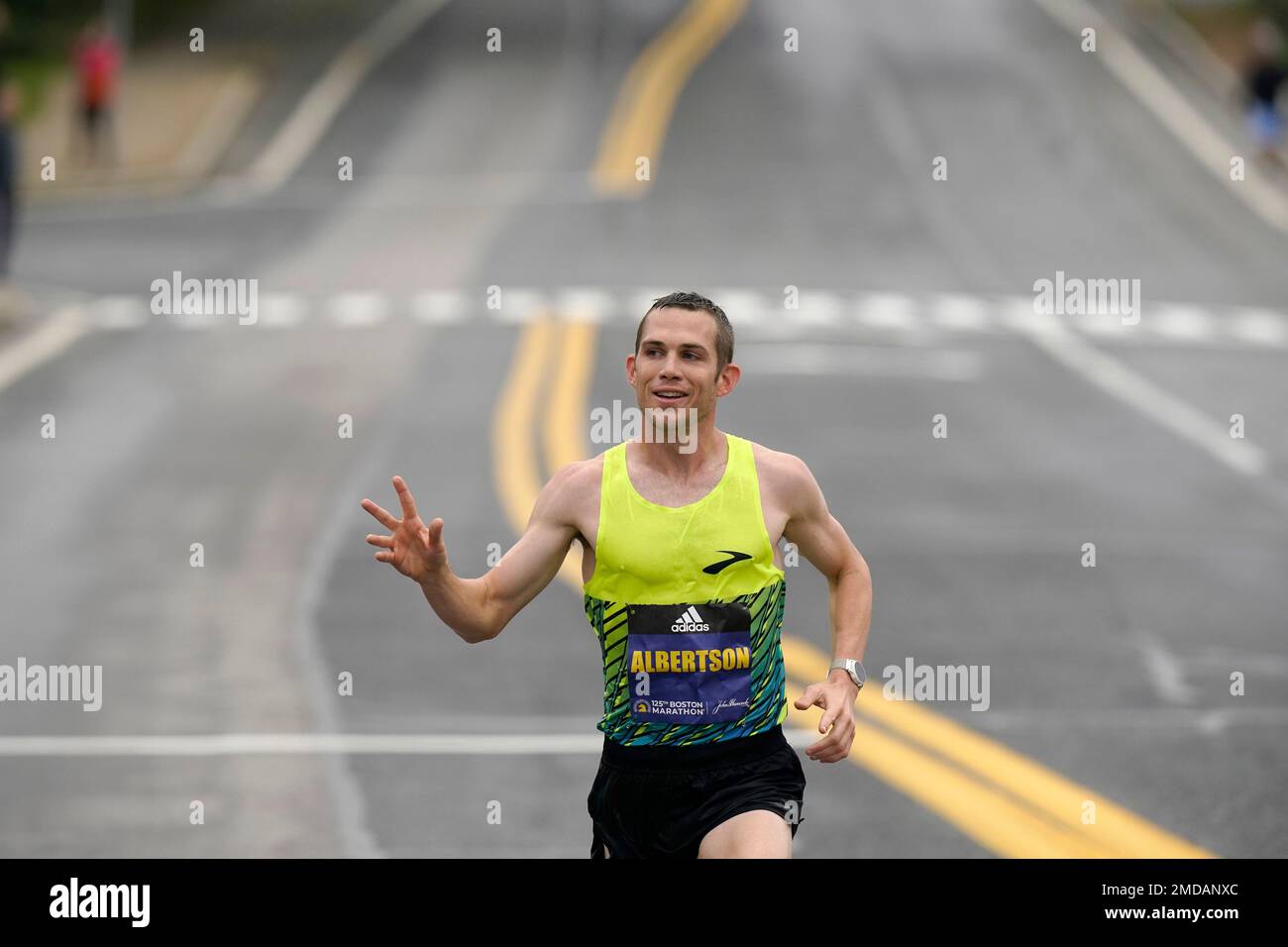 CJ Albertson waves to people along the route as he leads the race ...