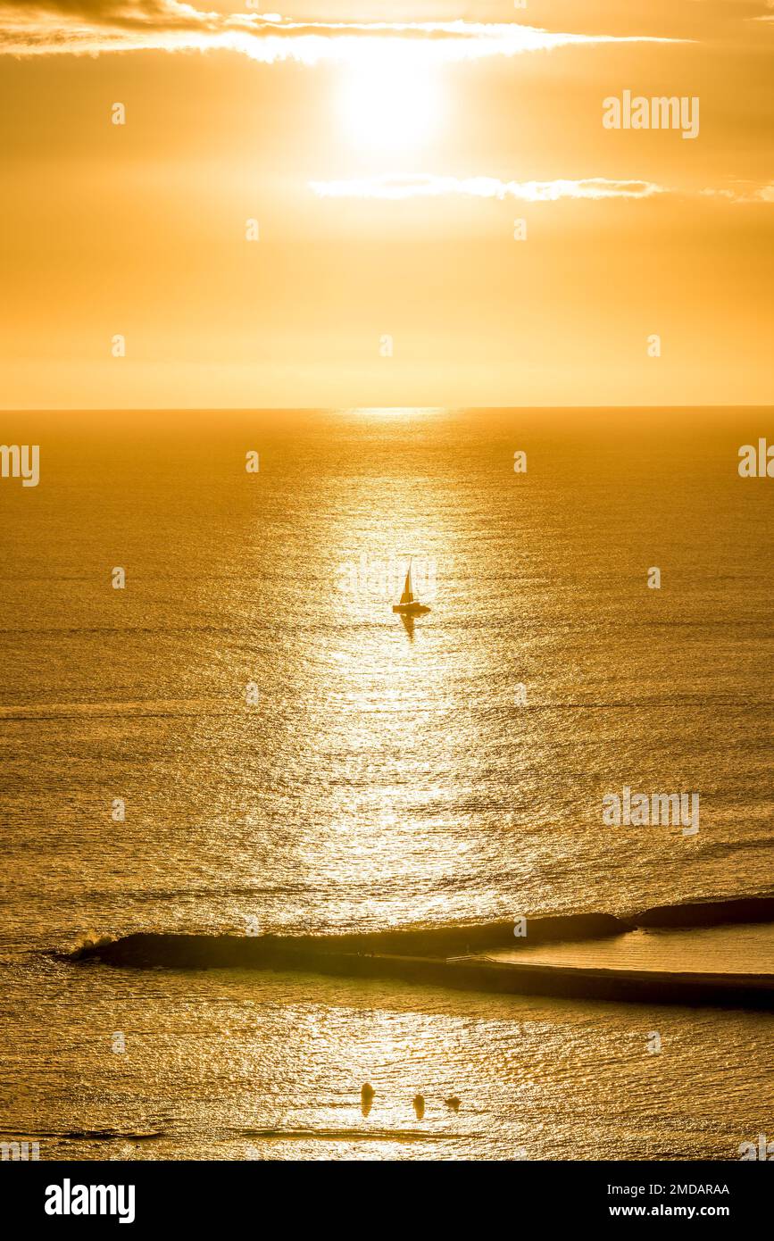 Sunset over a single sailboat off Magic Island on Oahu, Hawaii Stock ...