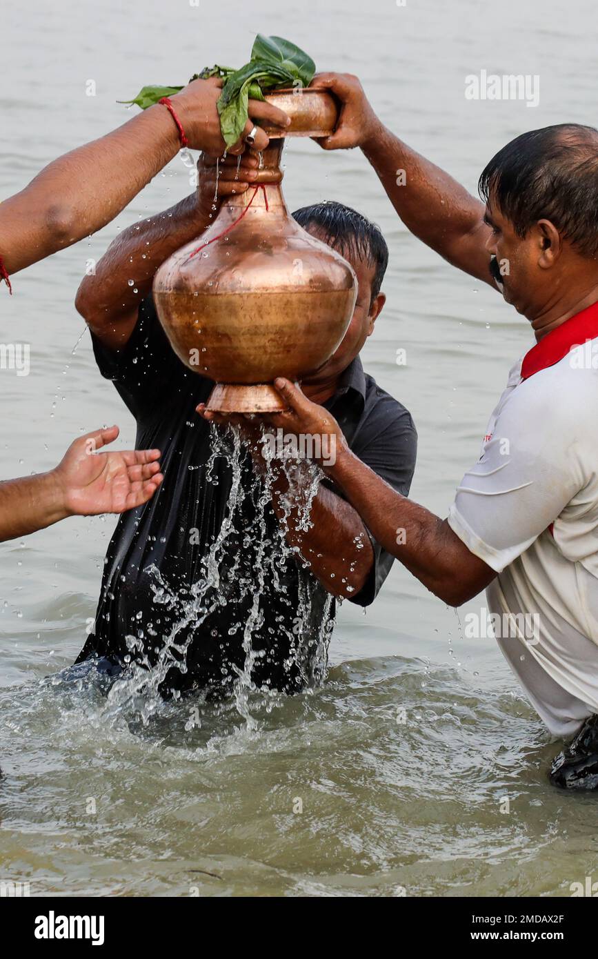 Hindu devotees fetch holy water in a copper pot from the Hooghly River ...