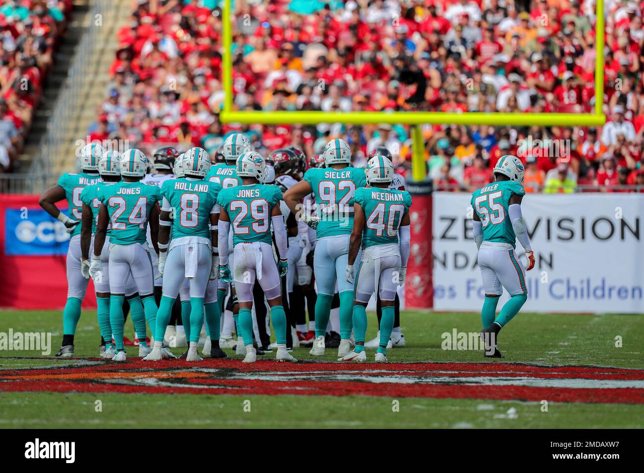 The Miami Dolphins players watch the scoreboard during a NFL football ...