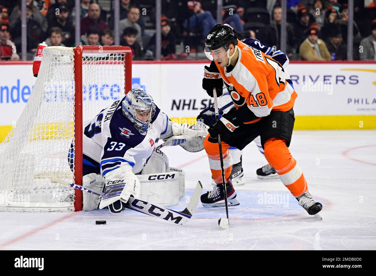 Winnipeg Jets goaltender David Rittich, left, makes a save past ...