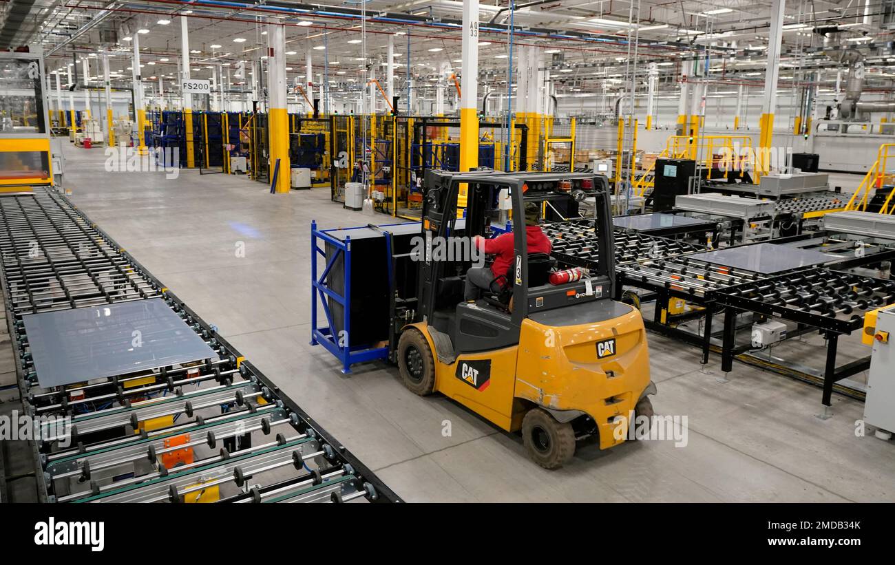 Towmotor driver Corey Reid transports solar panels at the assembly line ...