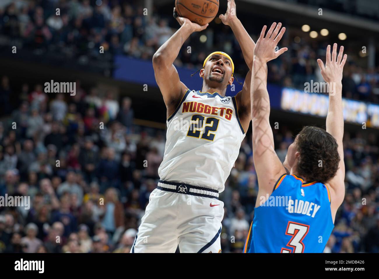 Denver Nuggets forward Zeke Nnaji, left, goes up for a basket as Oklahoma City Thunder guard ...