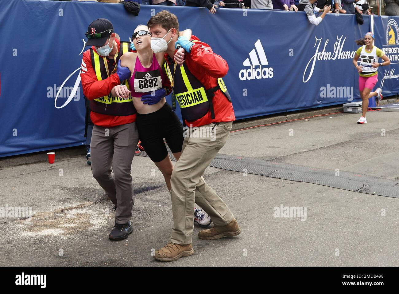 Doctors help Kathleen Hoeg after she crossed the finish line at the ...