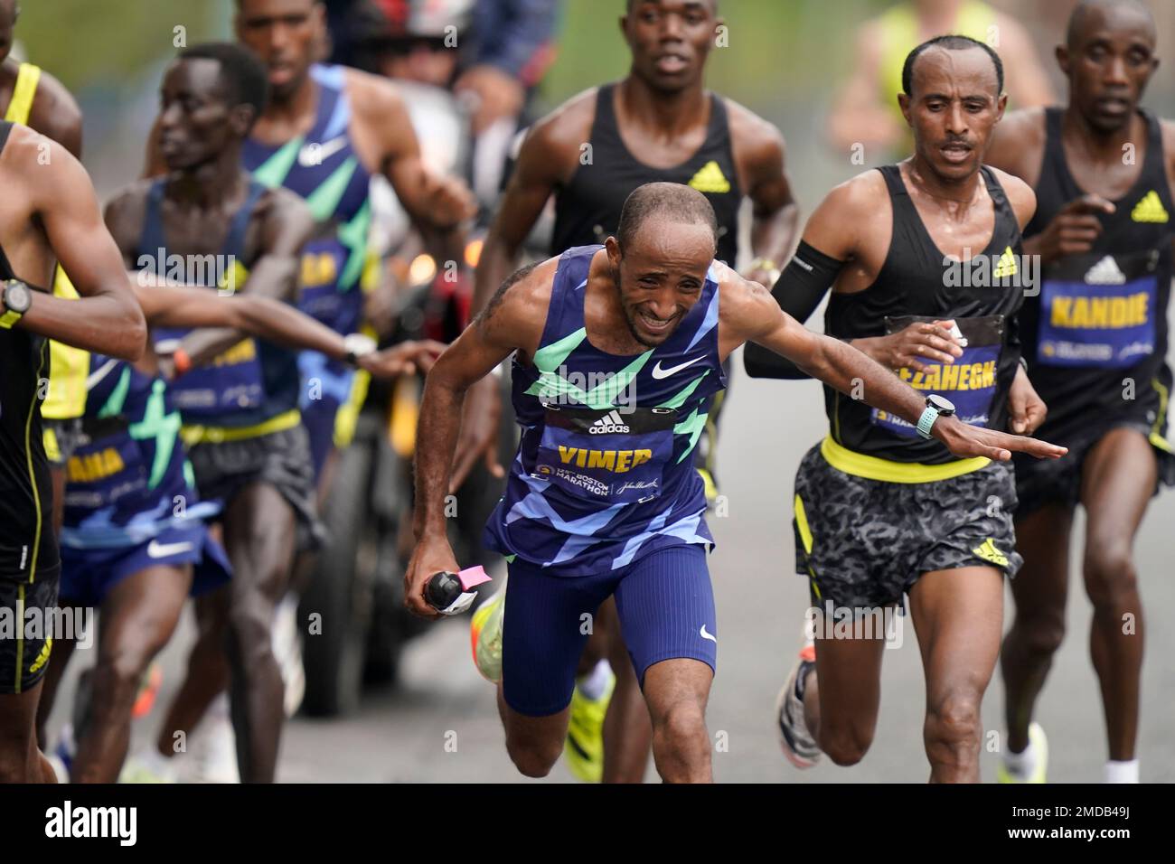 Jemal Yimer, of Addis Ababa, Ethiopia, center, stumbles while running ...