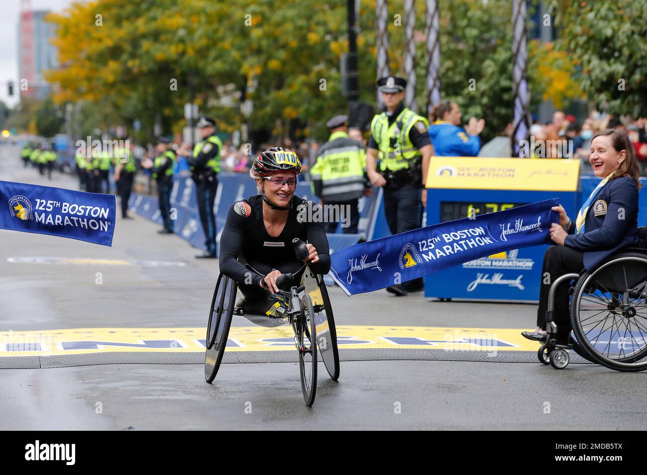 Manuela Schar, of Switzerland, breaks the tape to win the women's ...